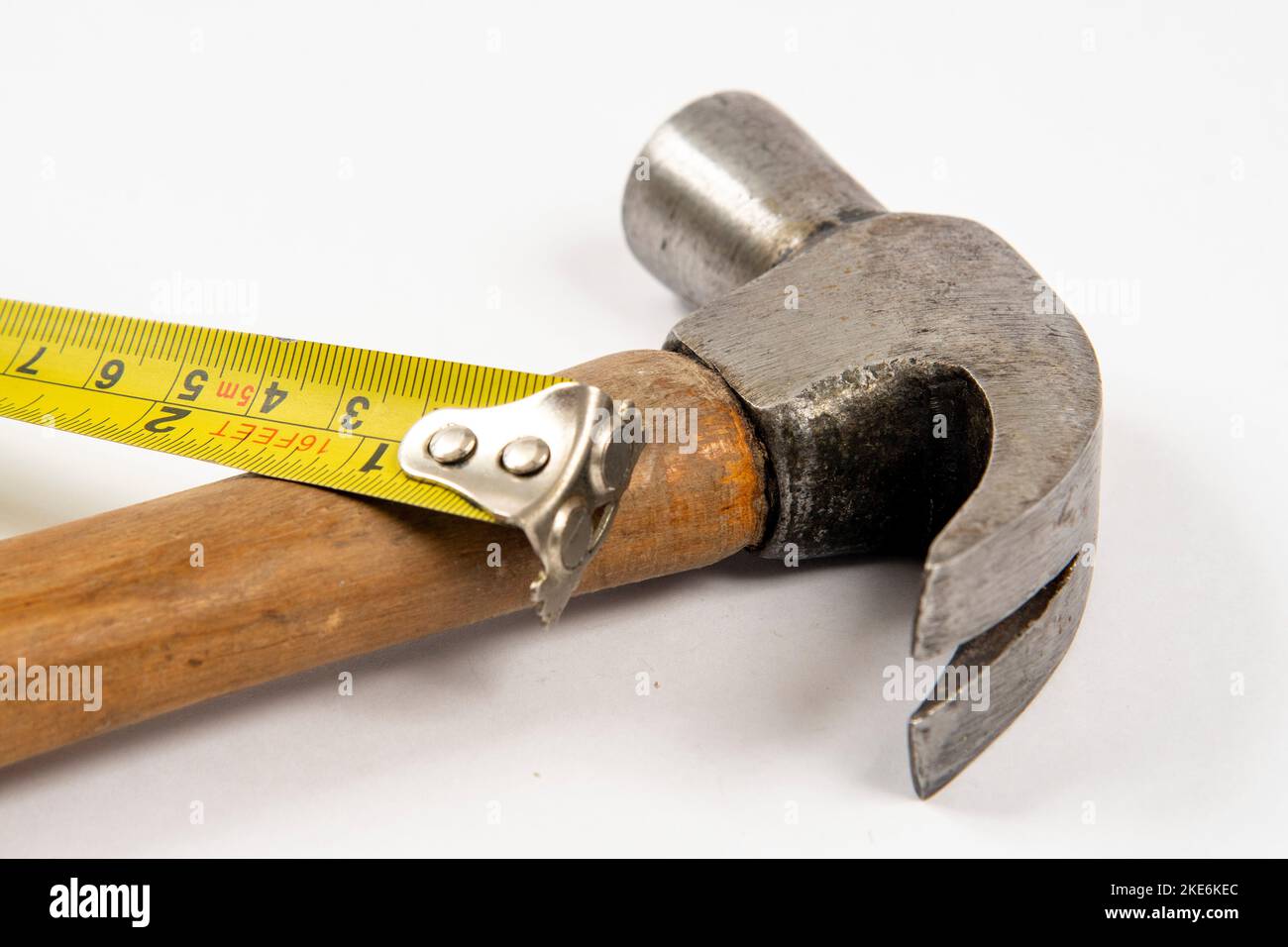 yellow tape measure and hammer im white background Stock Photo - Alamy