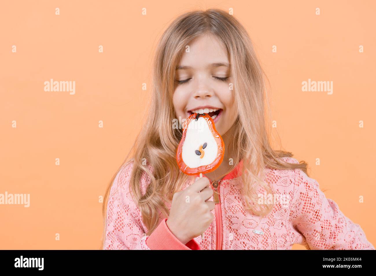 Cute little child enjoy eating sweets candy Stock Photo - Alamy
