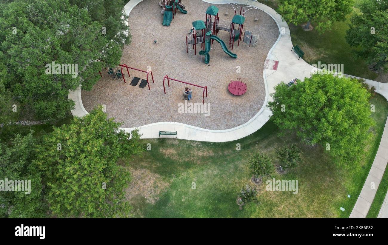 An aerial view of a children's playground in a park surrounded by green ...
