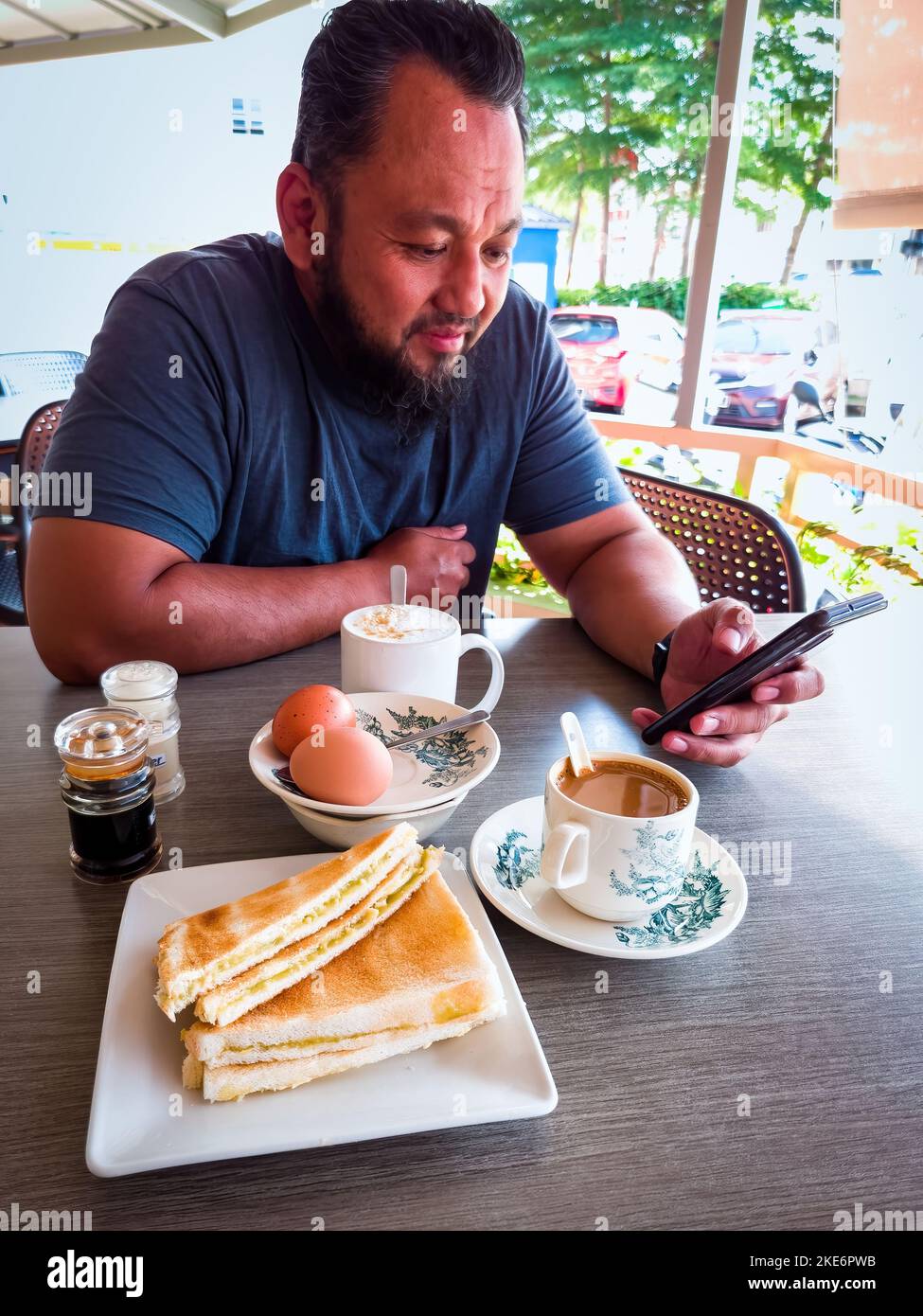 Asian traditional breakfast combination of half boiled eggs, toast ...