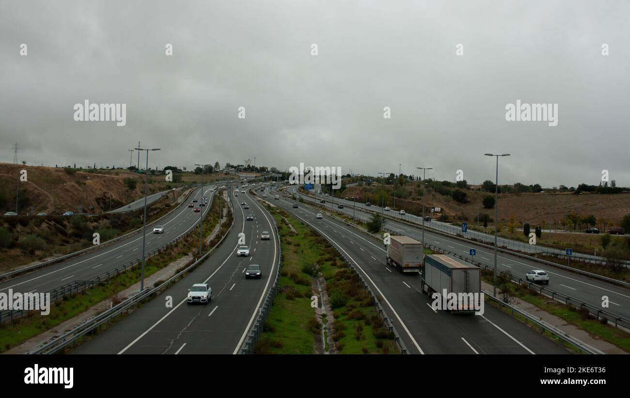 highway with heavy traffic, with trucks and cars on a cloudy day with ...