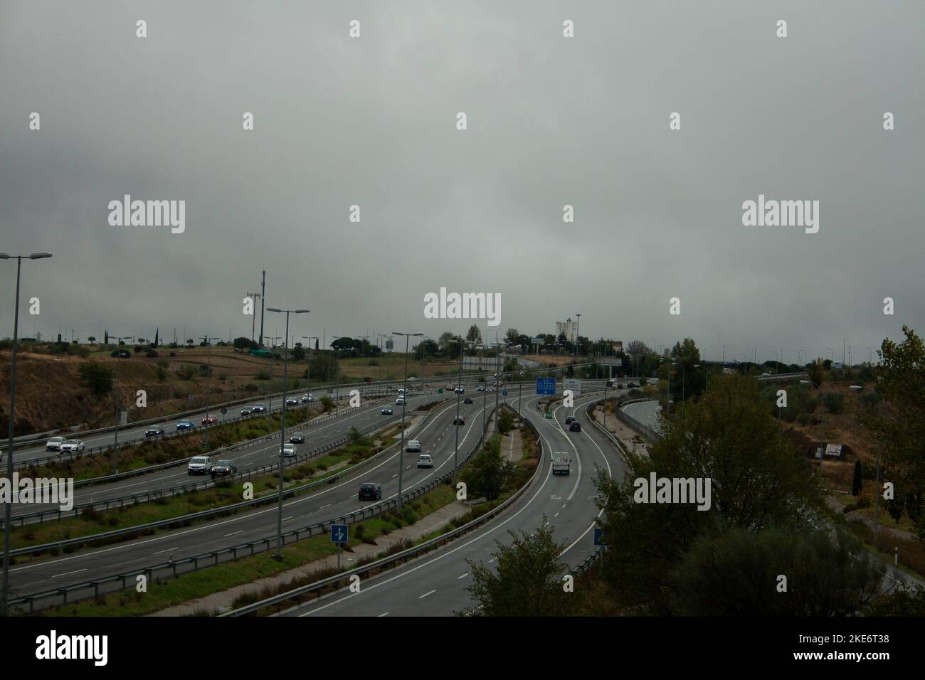 highway with heavy traffic, with trucks and cars on a cloudy day with ...