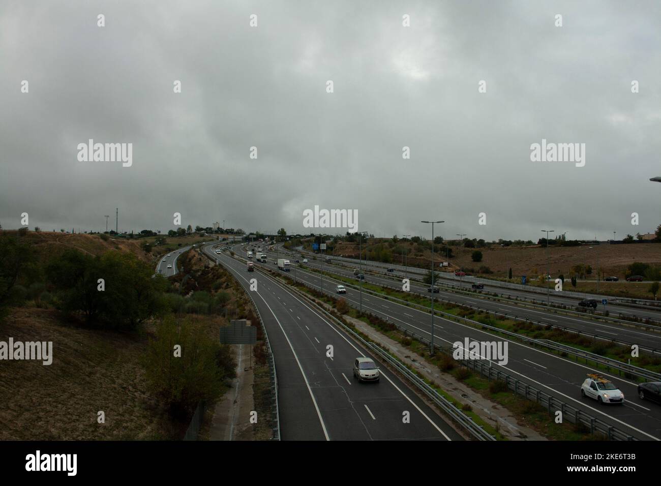 highway with heavy traffic, with trucks and cars on a cloudy day with ...
