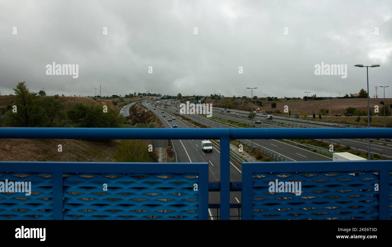 highway with heavy traffic, with trucks and cars on a cloudy day with ...