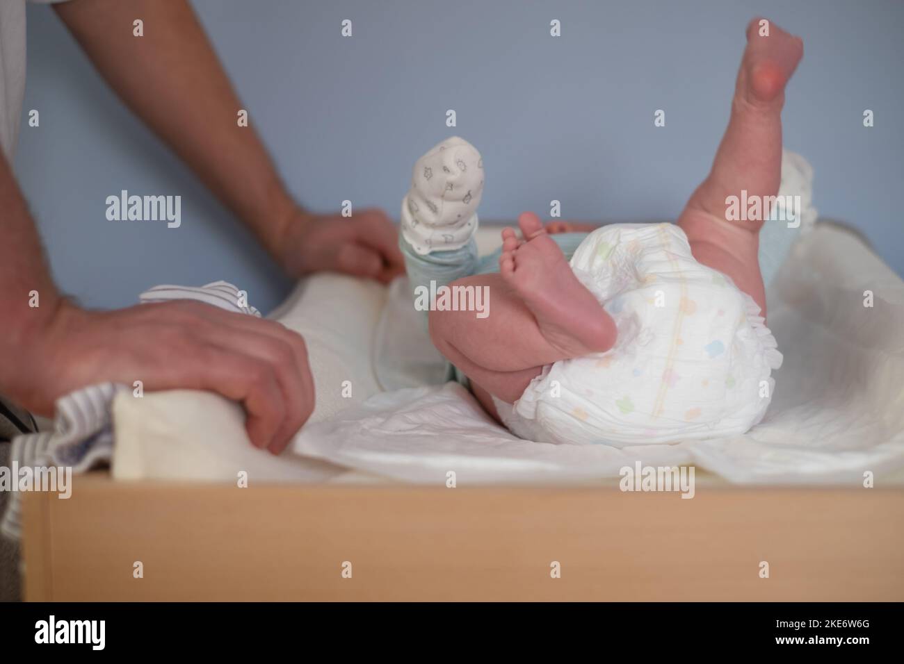 Newborn Baby legs on the changing table Stock Photo - Alamy