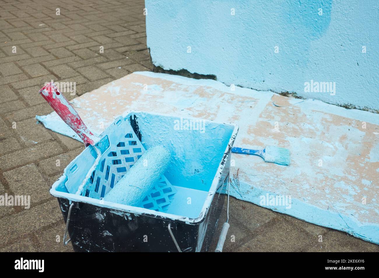 Roller with blue paint. DIY concept. incorrect wall painting Stock ...