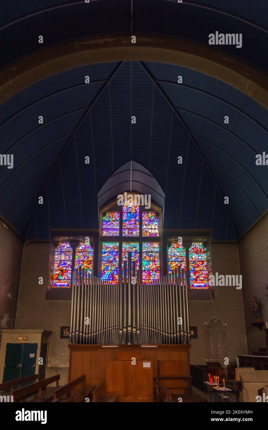 Beautiful old church named Eglise Saint-Remi or St Riok with blue ...