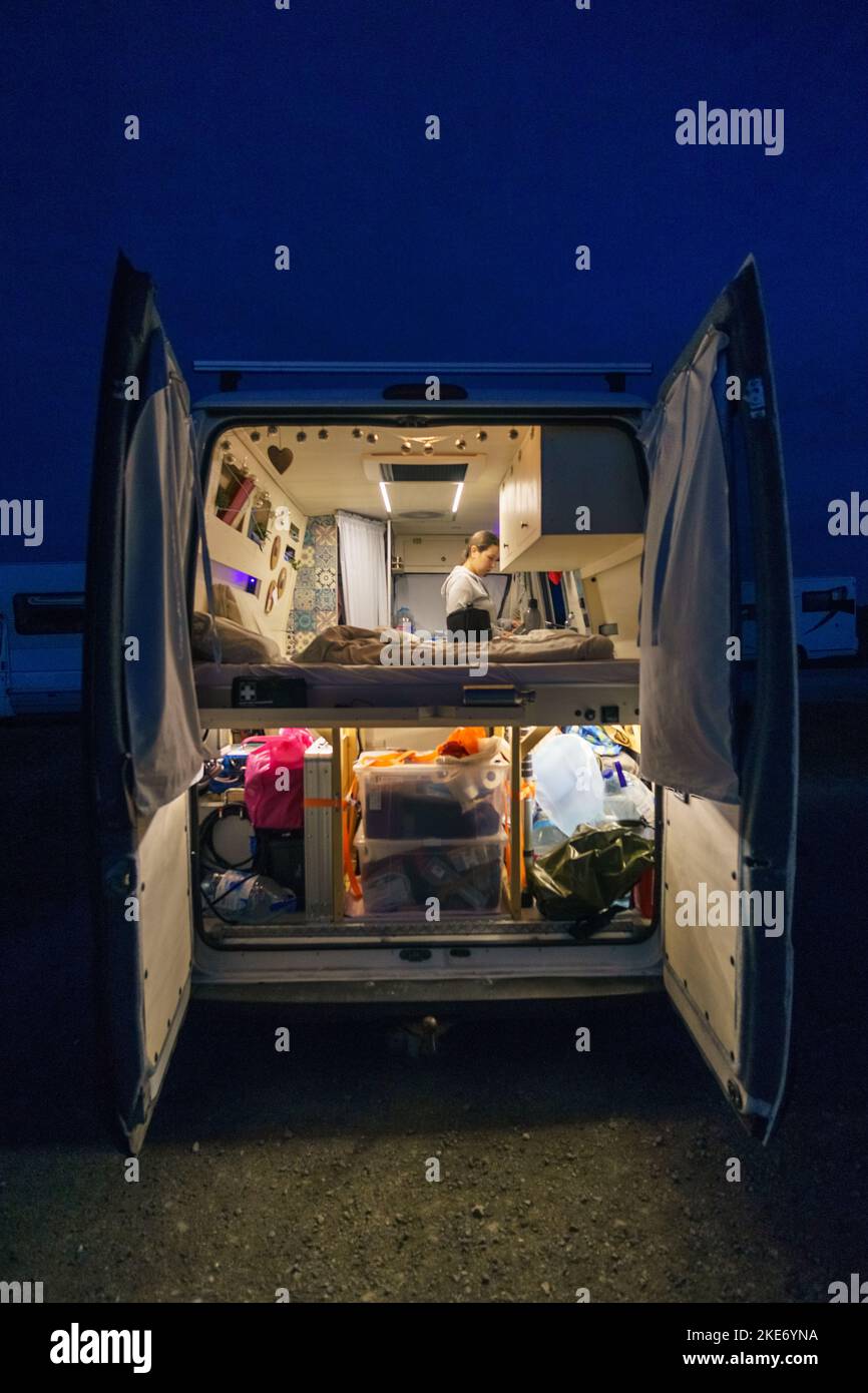 Rear doors opened at a do it yourself camper van with illuminated ...