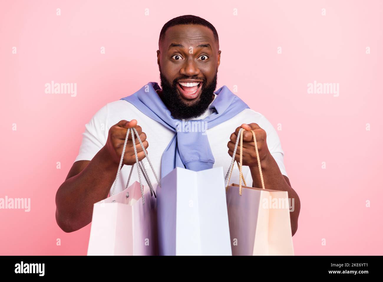 Photo of young good mood excited male go shopping buy present for his ...