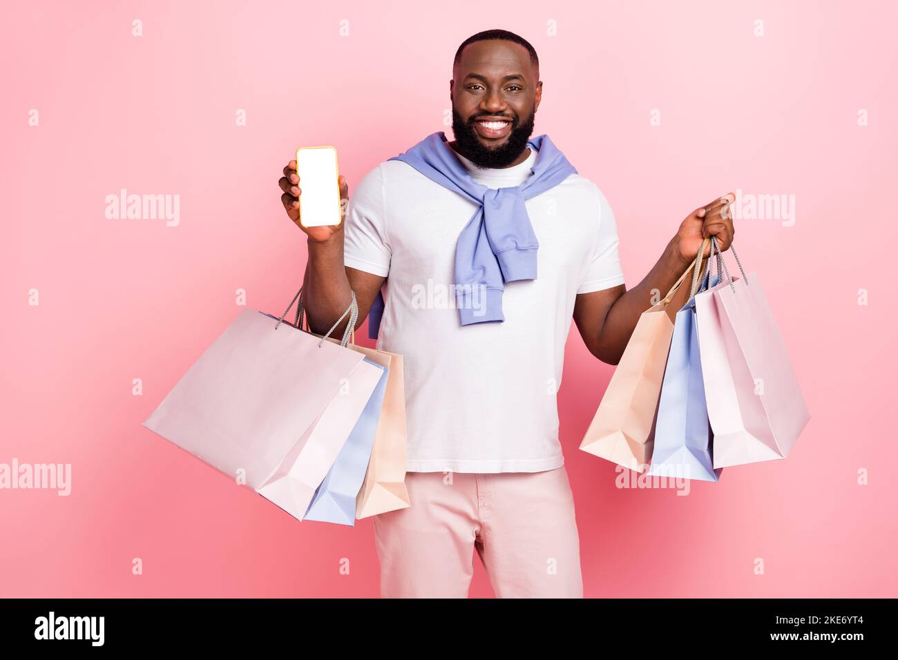 Photo of attractive male recommend you new online shop show phone touch ...