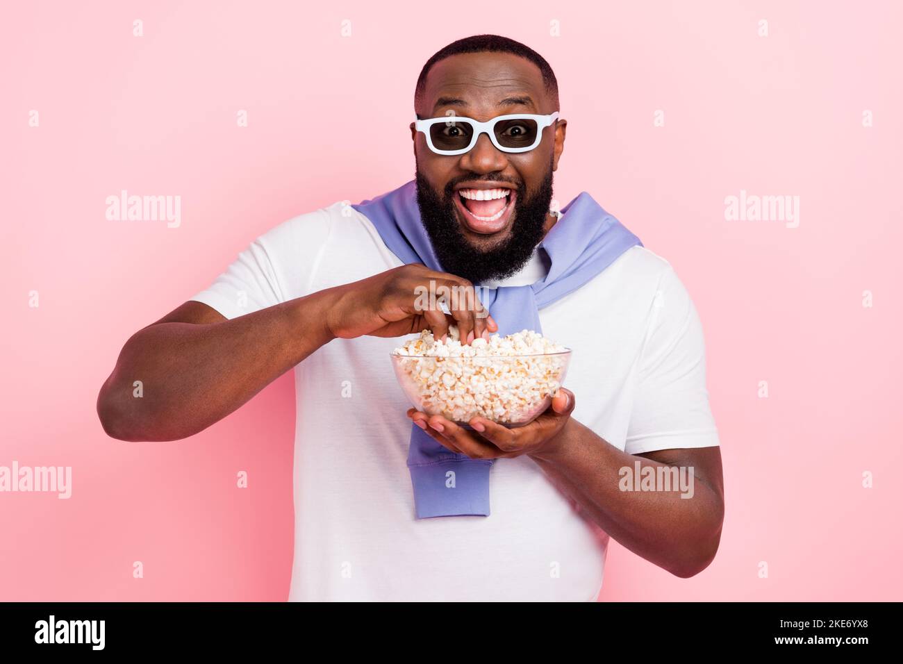 Bearded man eating popcorn watching hi-res stock photography and images ...
