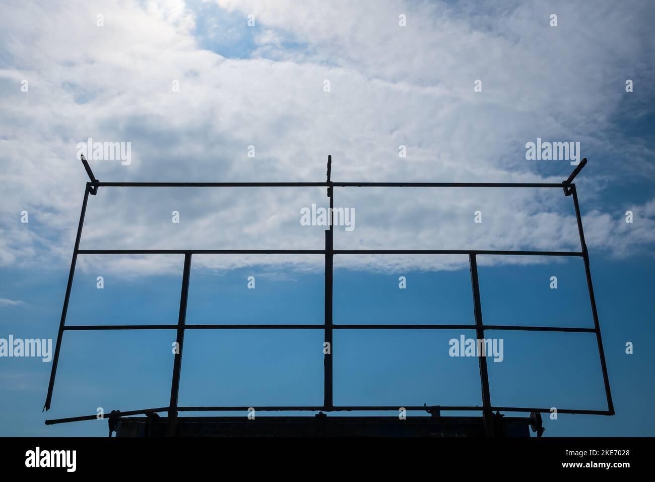 An old rusted steel billboard frame in a blue sky background Stock ...