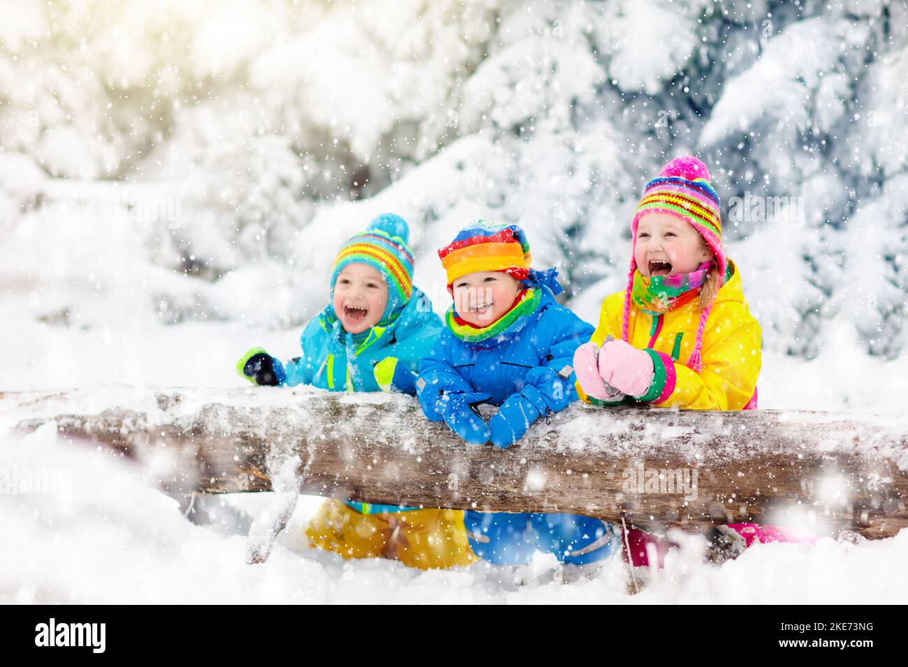 Kids playing in snow. Children play outdoors on snowy winter day. Boy ...