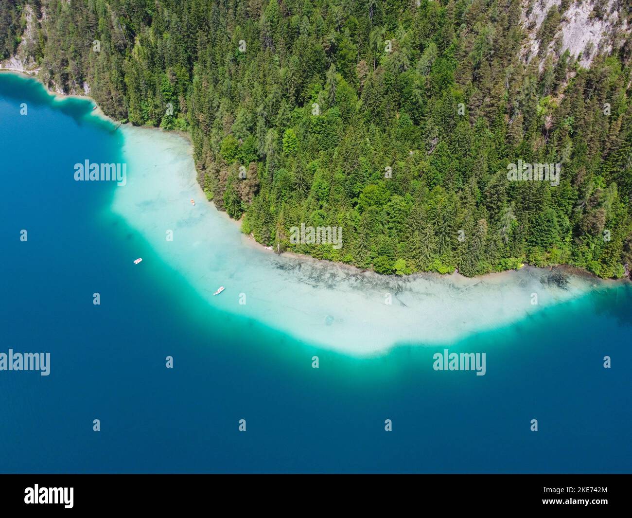 An aerial of the Australian Weissensee lake view with a shore and green ...