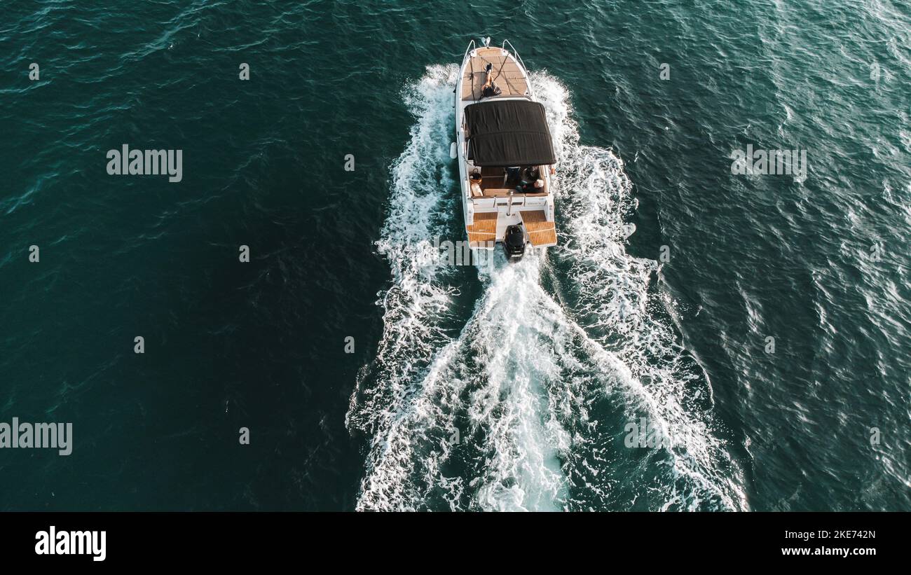 An aerial of a white boat flowing in the sea and making a wave Stock ...