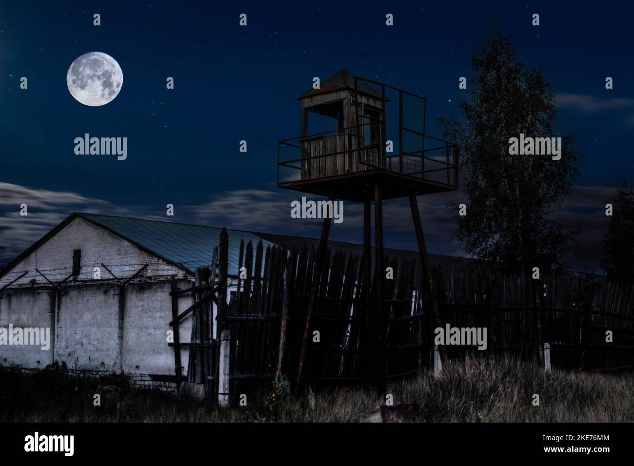 Old observation tower in old Soviet Russian prison complex at moonlight ...