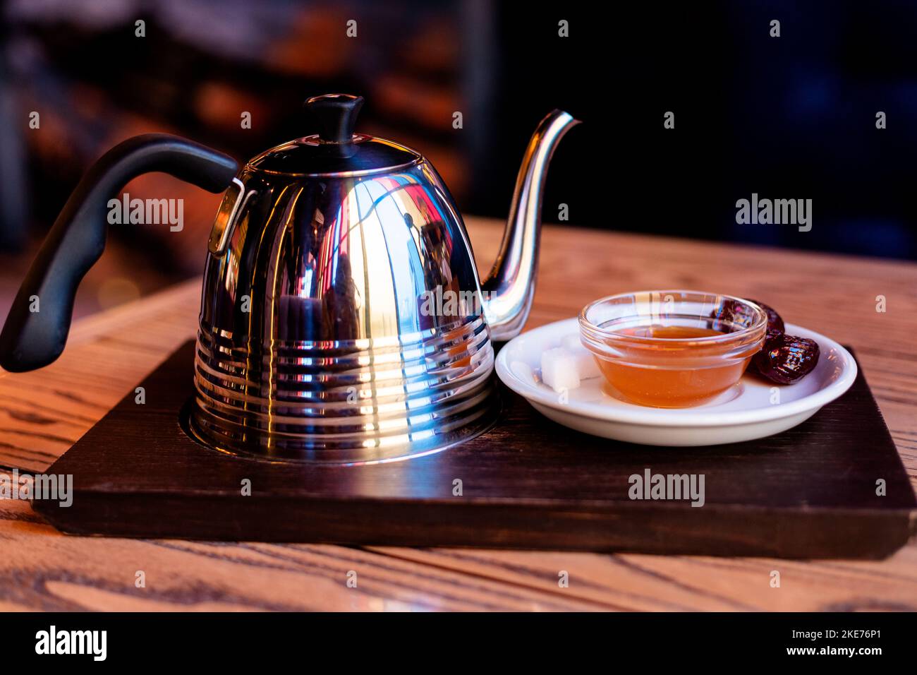 Metal kettle on a wooden table and jam. Tea Party Stock Photo - Alamy