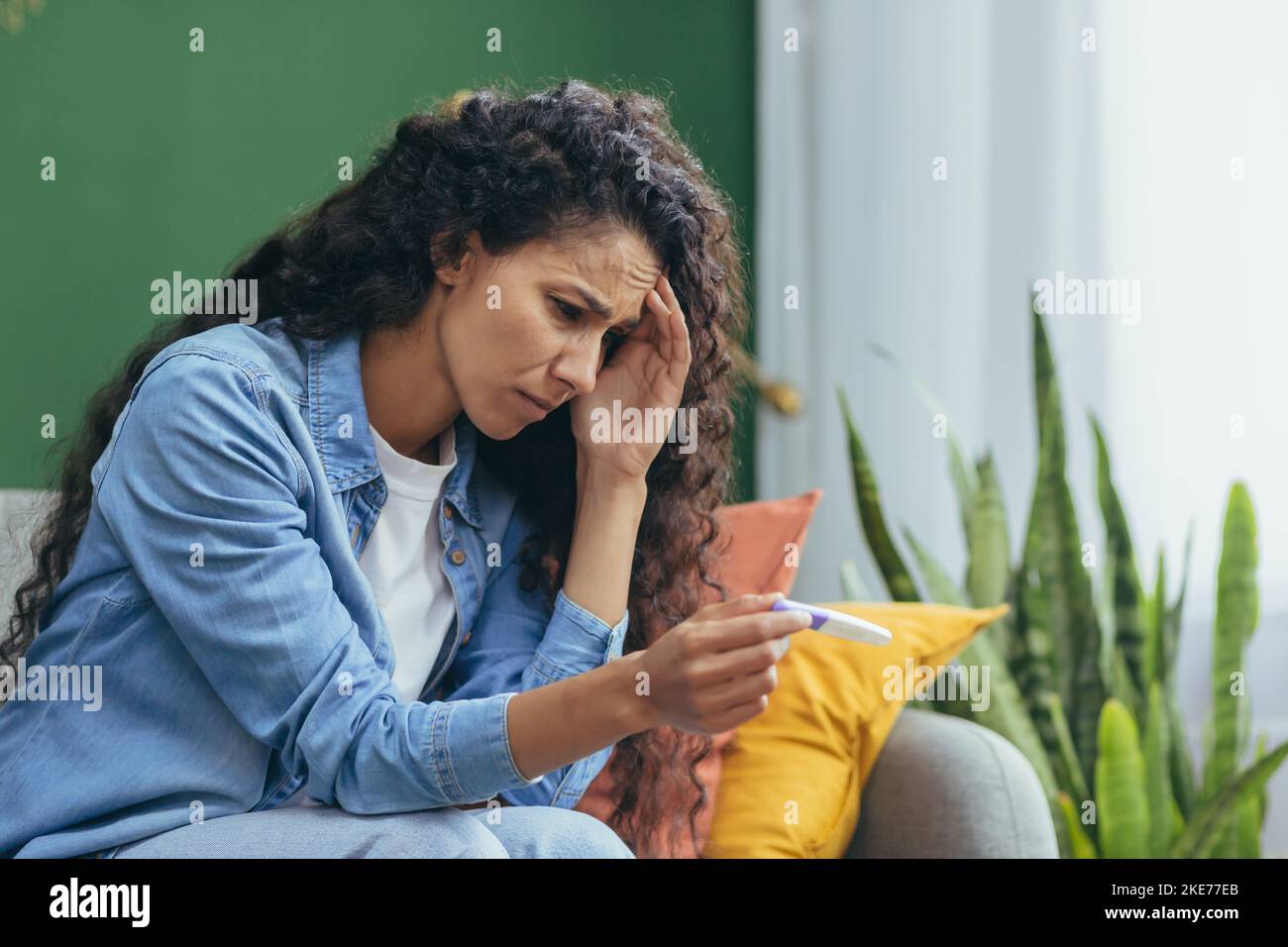 Sad And Upset Woman Alone At Home Unhappy With Pregnancy Test