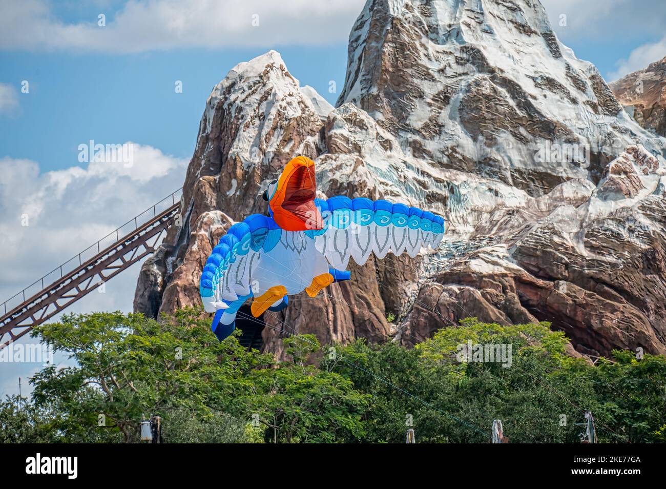 Large parrot shaped Kite flying through the air Stock Photo - Alamy