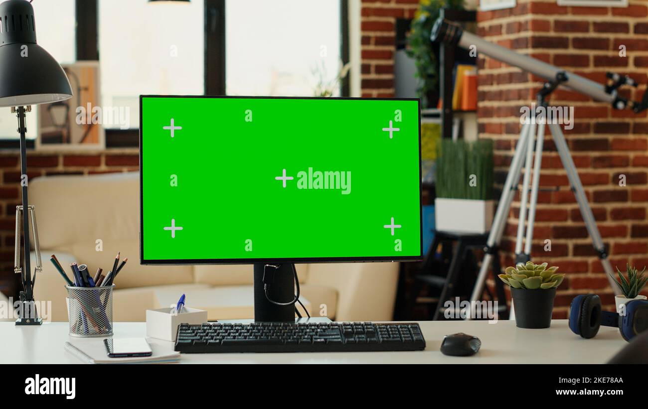 Empty desk with computer and greenscreen on monitor, showing chroma key ...