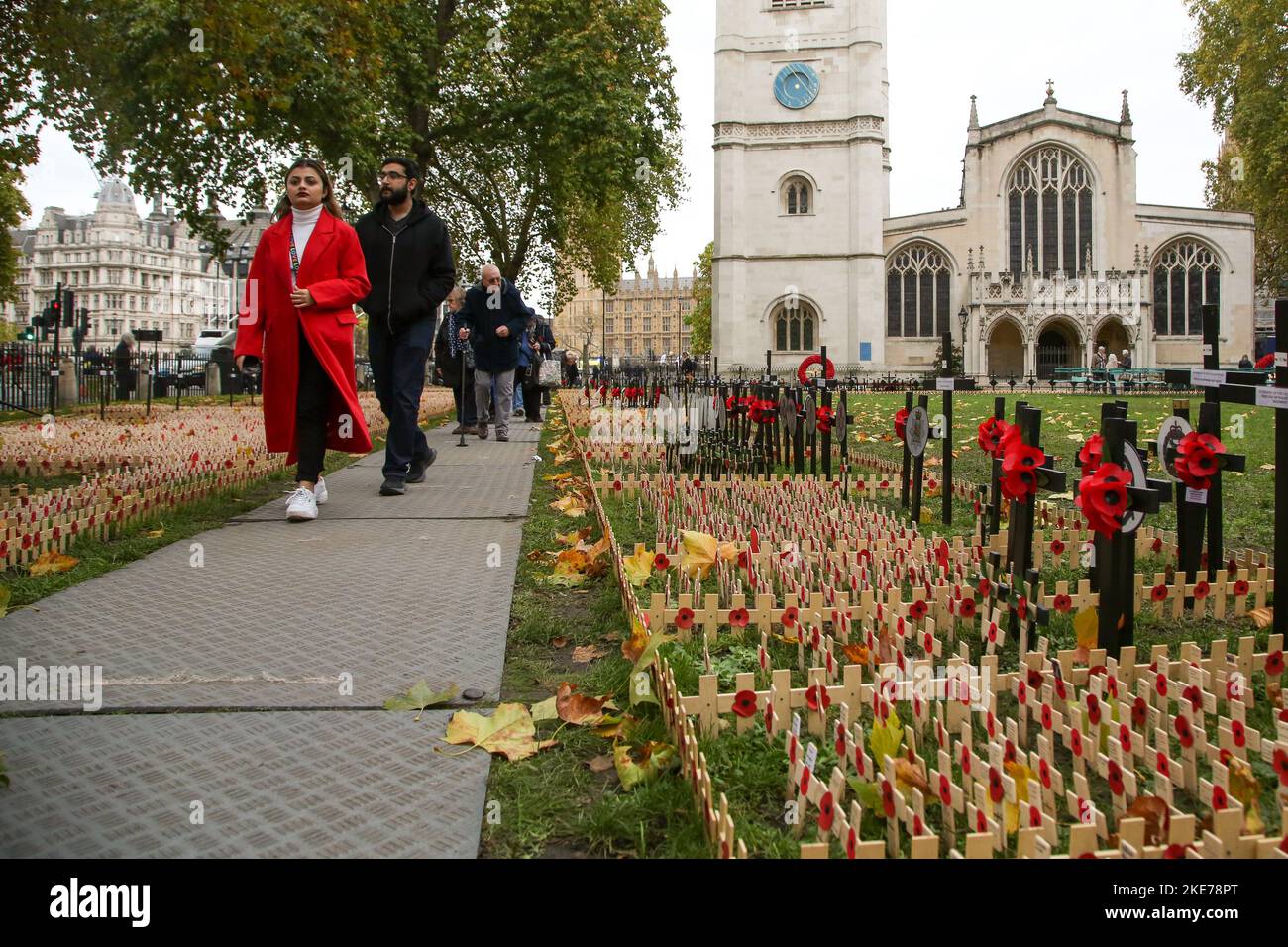 People walk past crosses with poppies laid by Poppy Factory at the ...