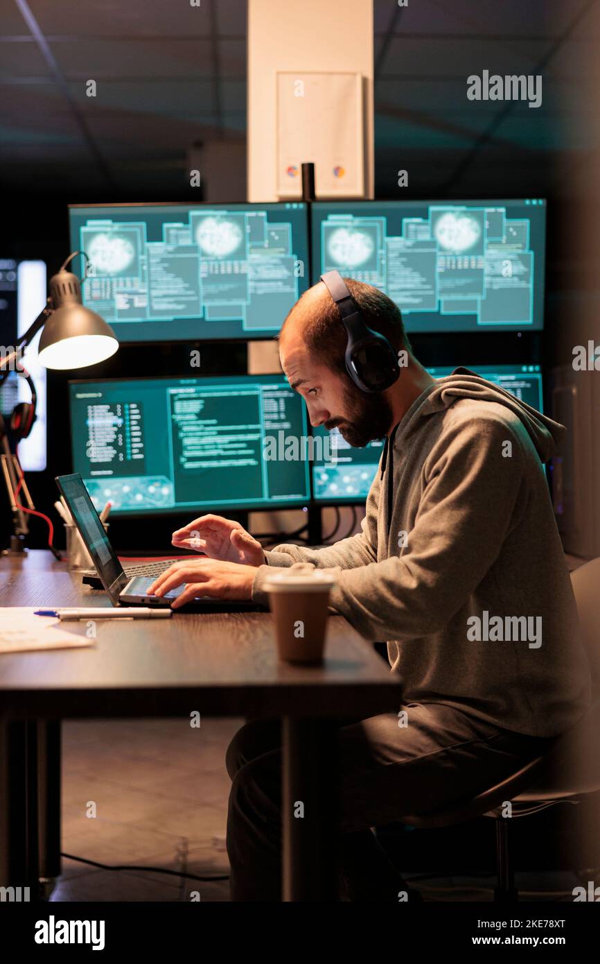 Cyber Criminal Trying To Hack Computer Server Wearing Headphones And