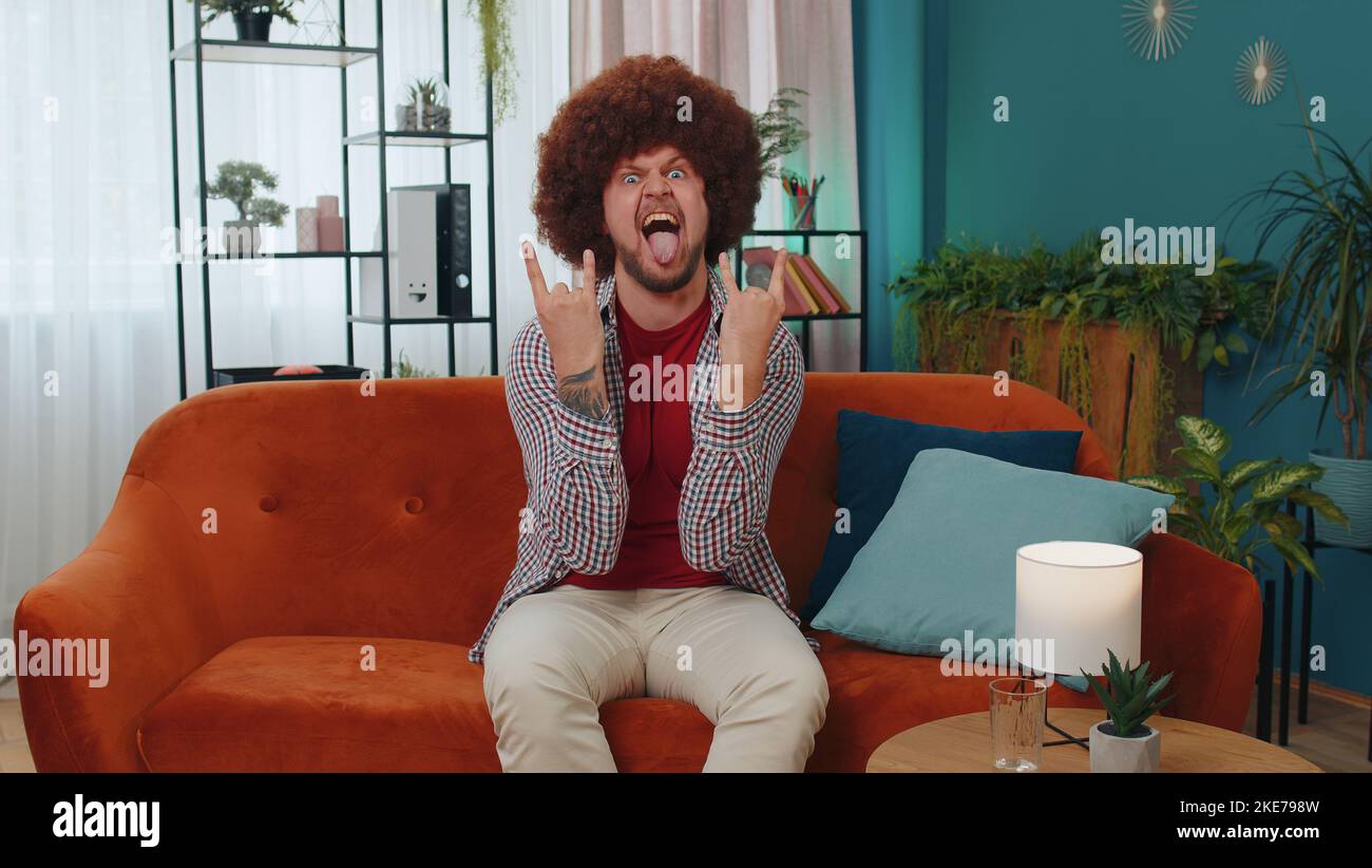 Overjoyed delighted caucasian adult man showing rock n roll gesture by ...