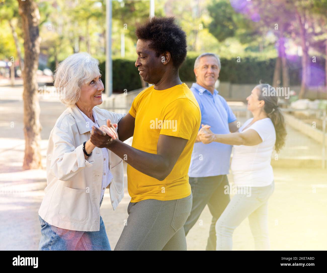 Happy positive smiling adult friends dancing pair dance in garden Stock ...