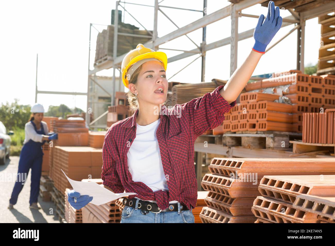 Female worker calling out for someone Stock Photo - Alamy