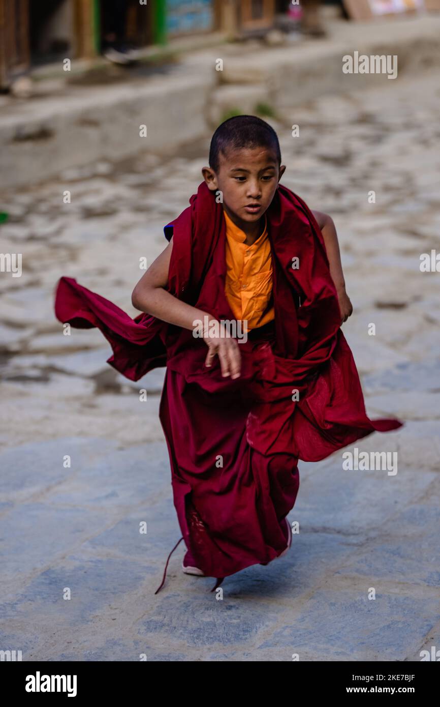 A vertical shot of a young Tibetan Buddhist Monk at the Tiji Festival ...