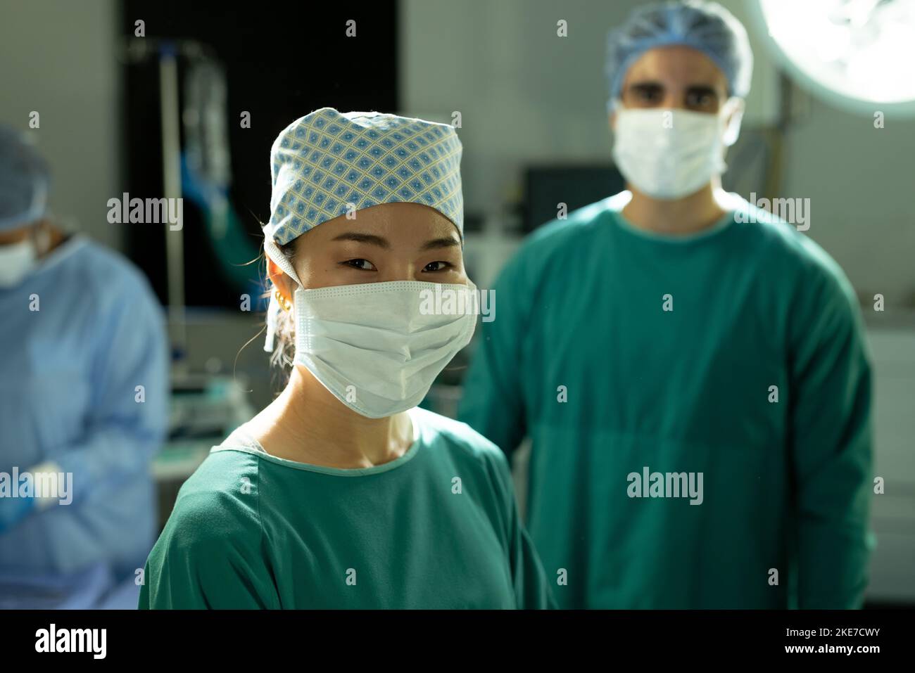 Portrait of happy asian female surgeon in surgical cap and mask in ...