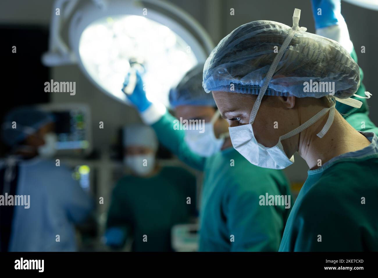 Caucasian female surgical tech and colleague adjusting lights in ...