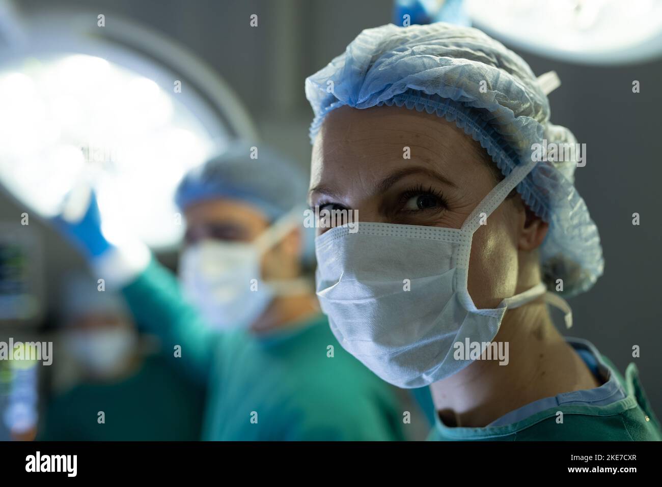 Portrait of smiling caucasian female surgeon during operation in ...