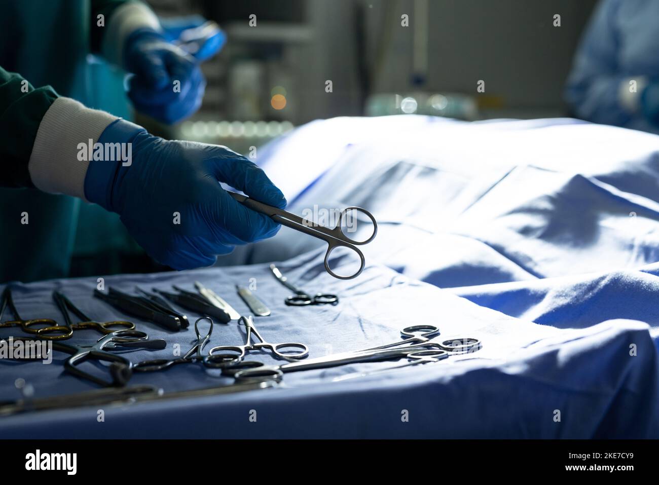 Hands of surgical tech picking up instrument for surgeon in operating ...
