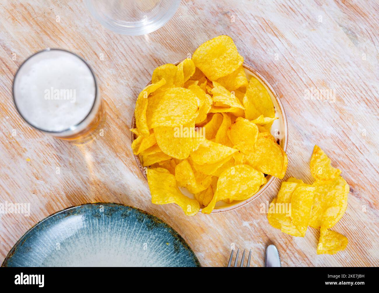 Crispy potato chips with glass of cold beer Stock Photo - Alamy