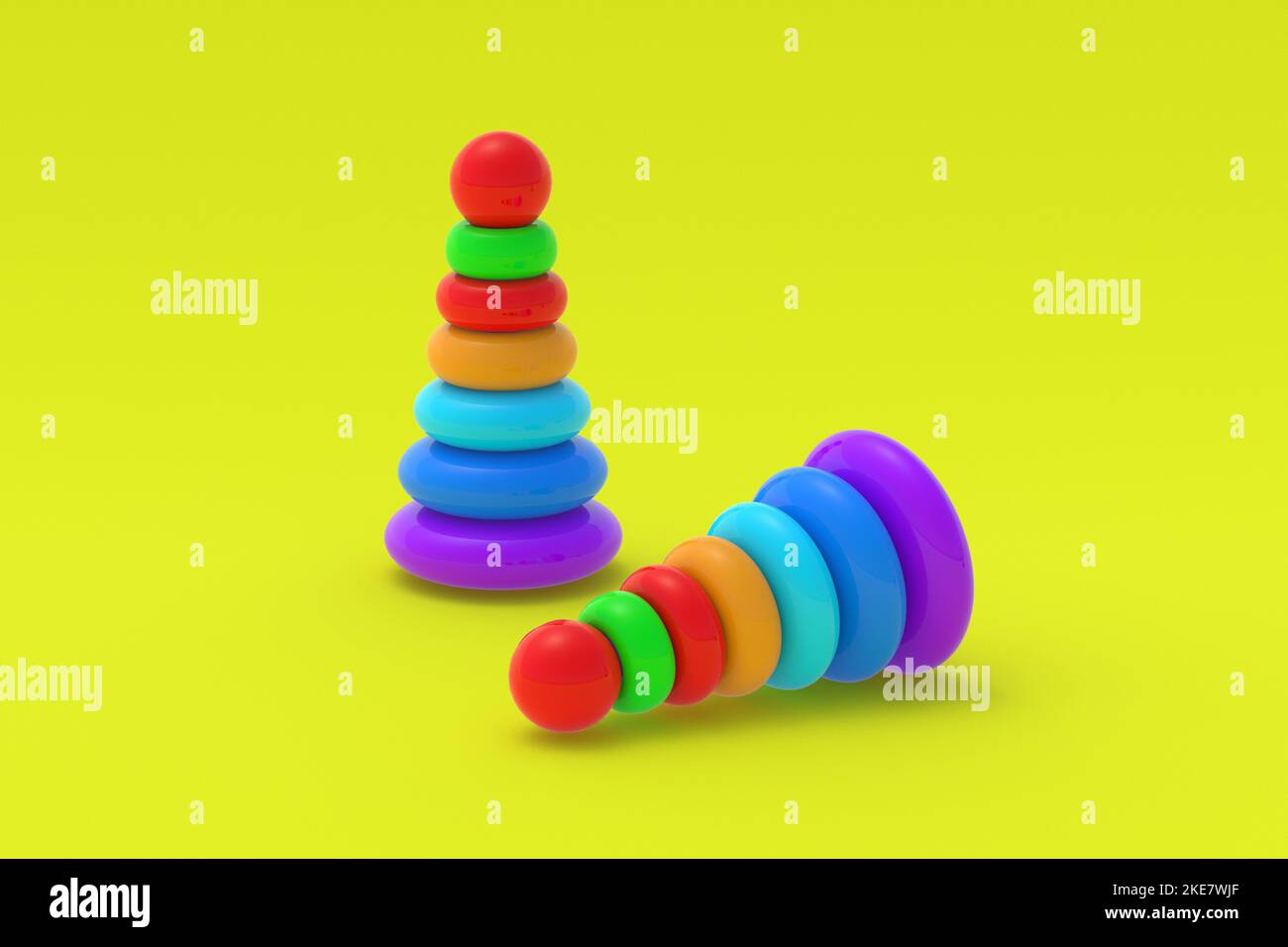 Two toy pyramid towers on yellow background. Children education ...