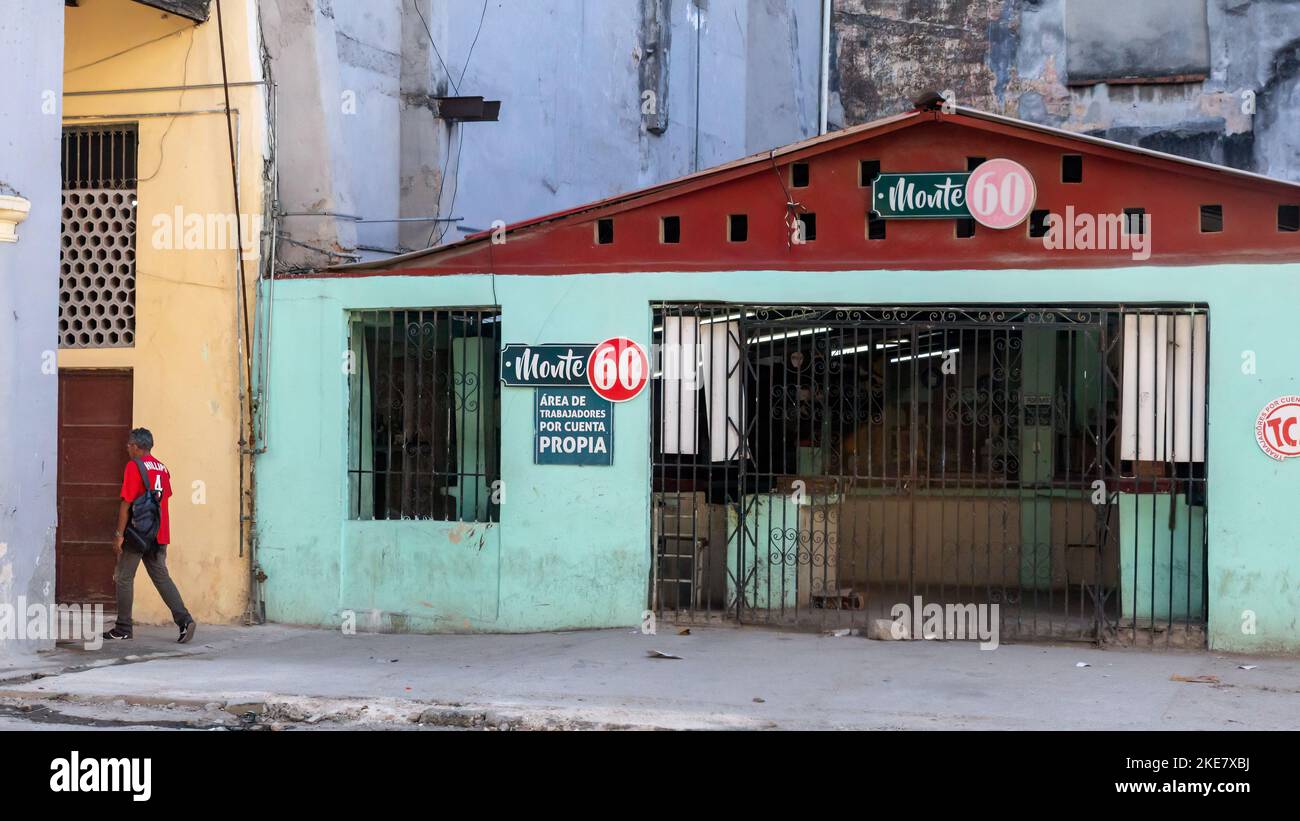 Facade of a closed building protected by metallic grilles. The exterior ...