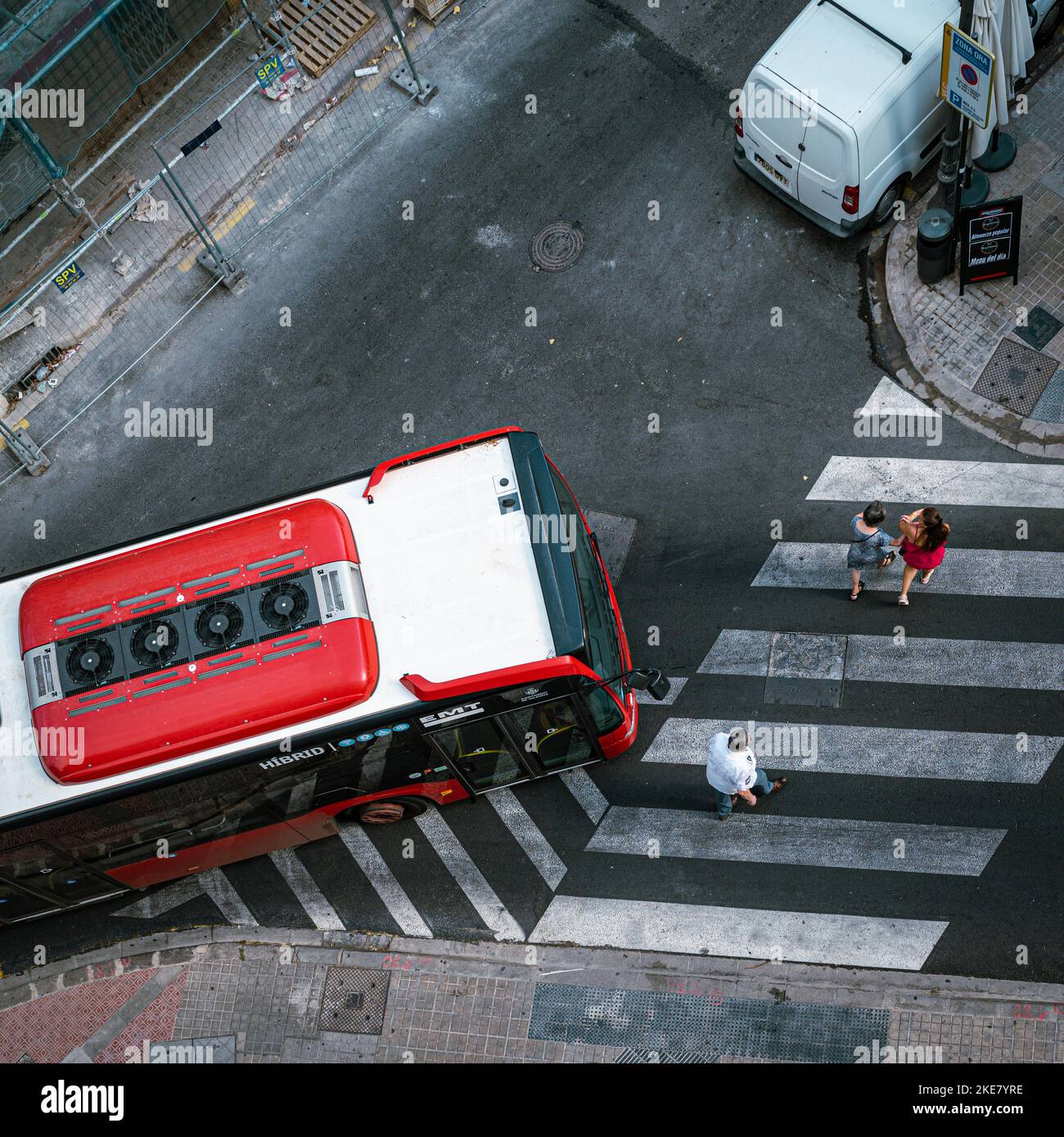 An aerial view of a city bus in Valencia taken from a balcony, and ...