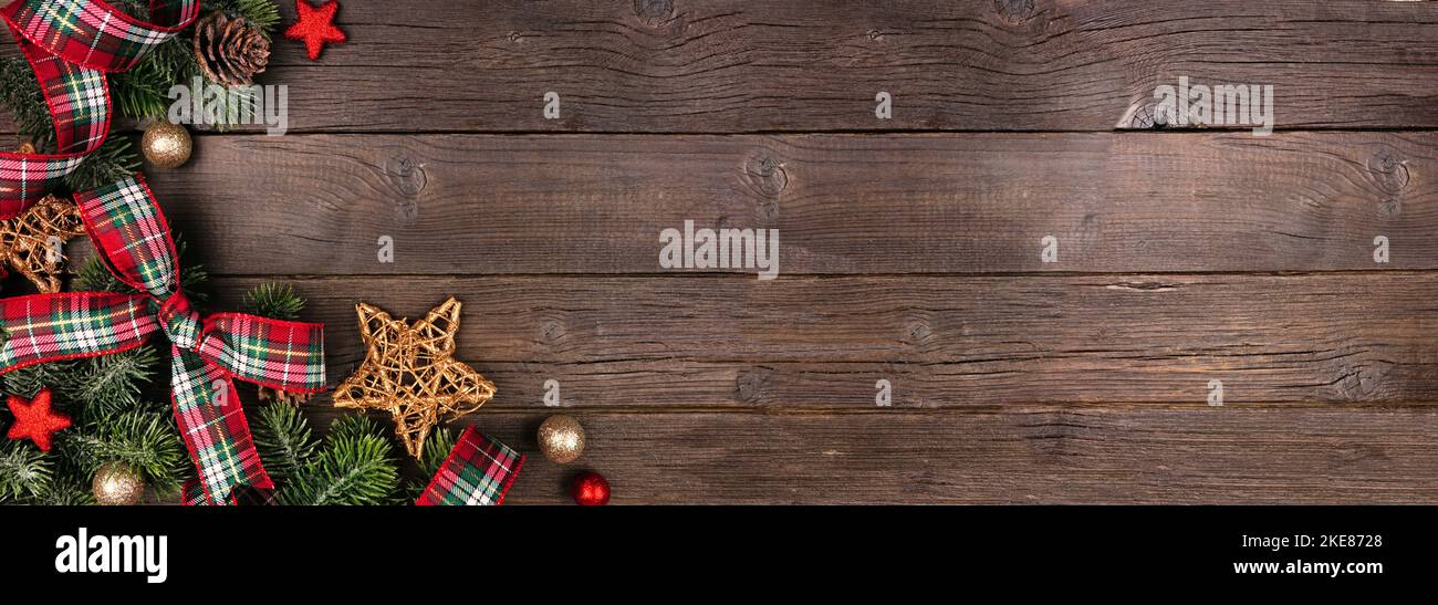 Christmas corner border of ornaments, branches and red and green plaid ...