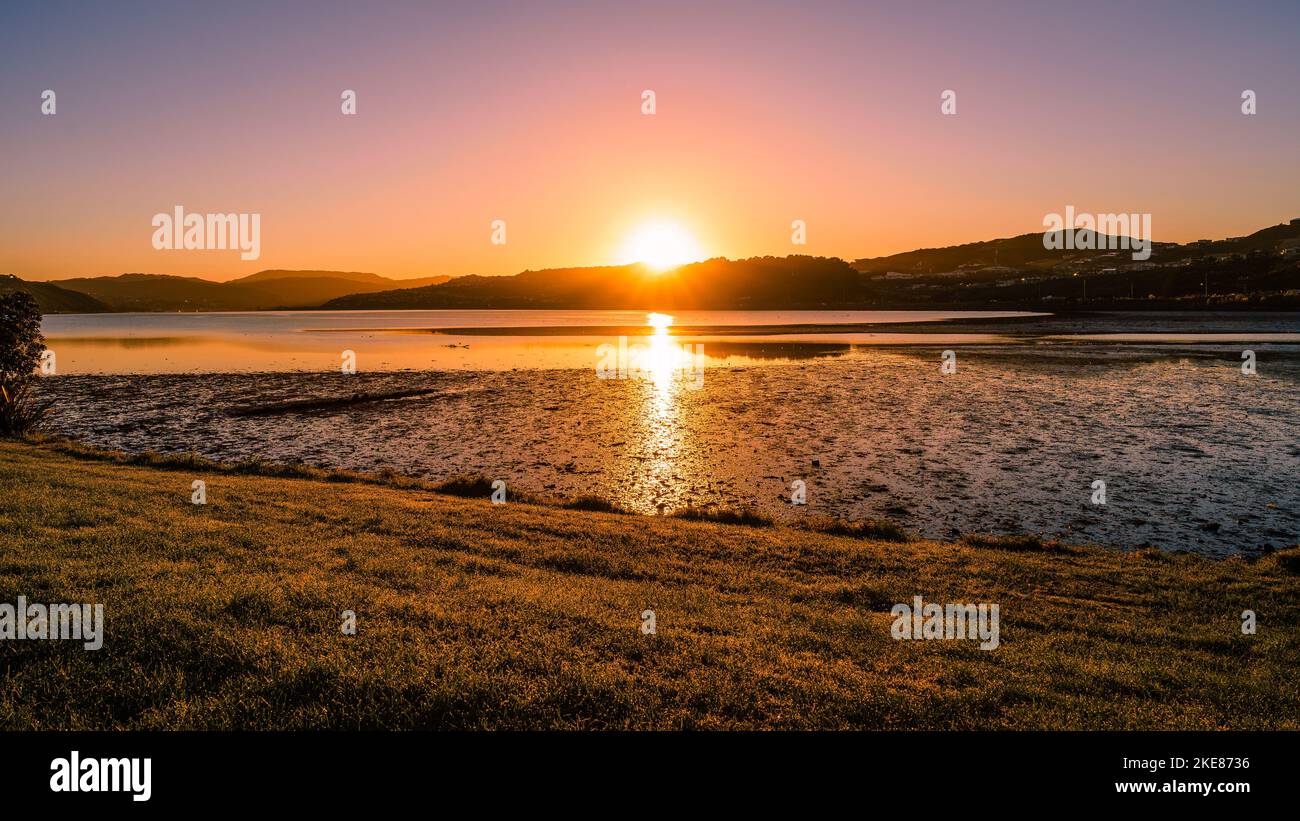 A beautiful sea view at sunset under a beautiful orange sky Stock Photo ...