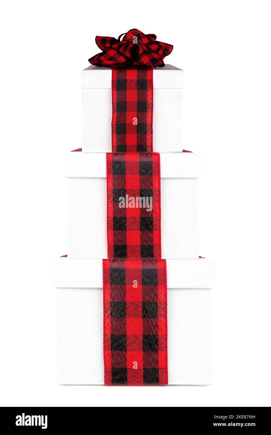 Stacked white Christmas gift boxes with red and black buffalo plaid bow ...
