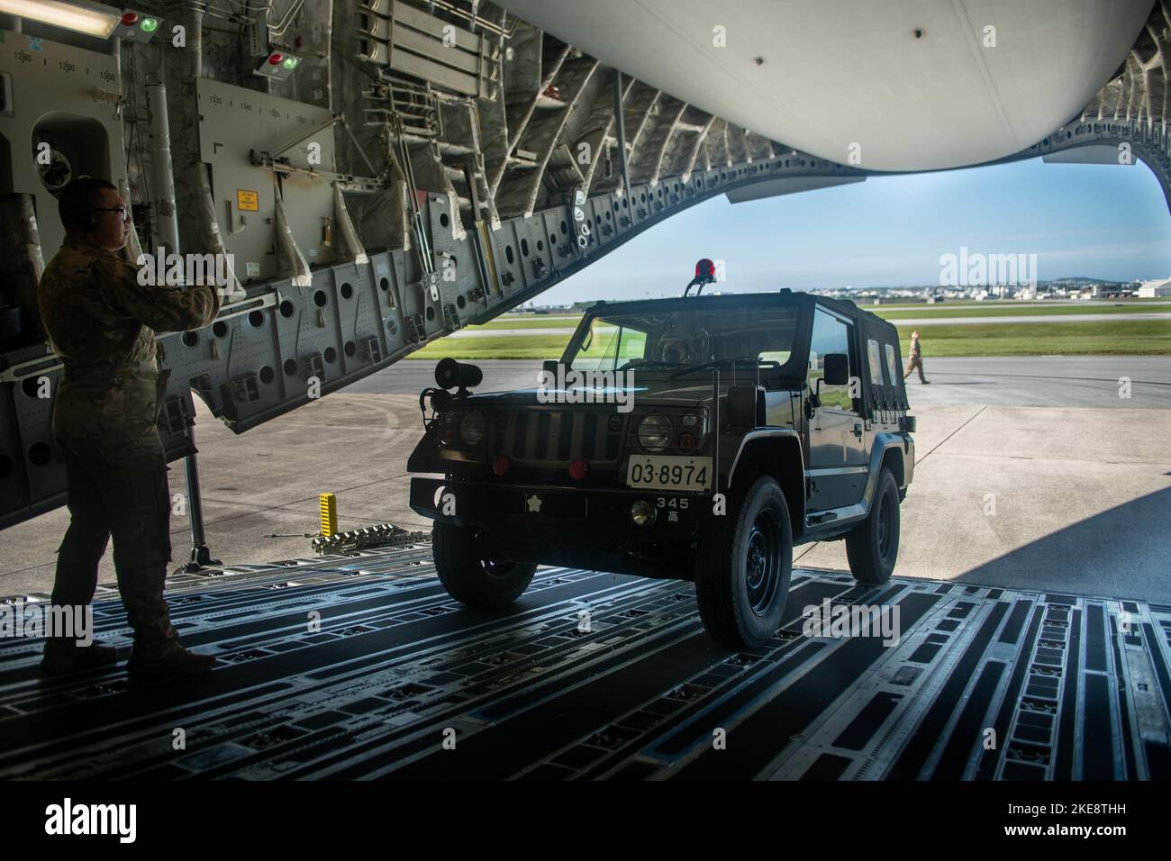 An airman from the 733d Air Mobility Squadron guides a Japan Ground ...