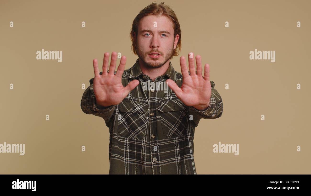 No stop. Serious adult man say No, hold palm folded crossed hands in ...