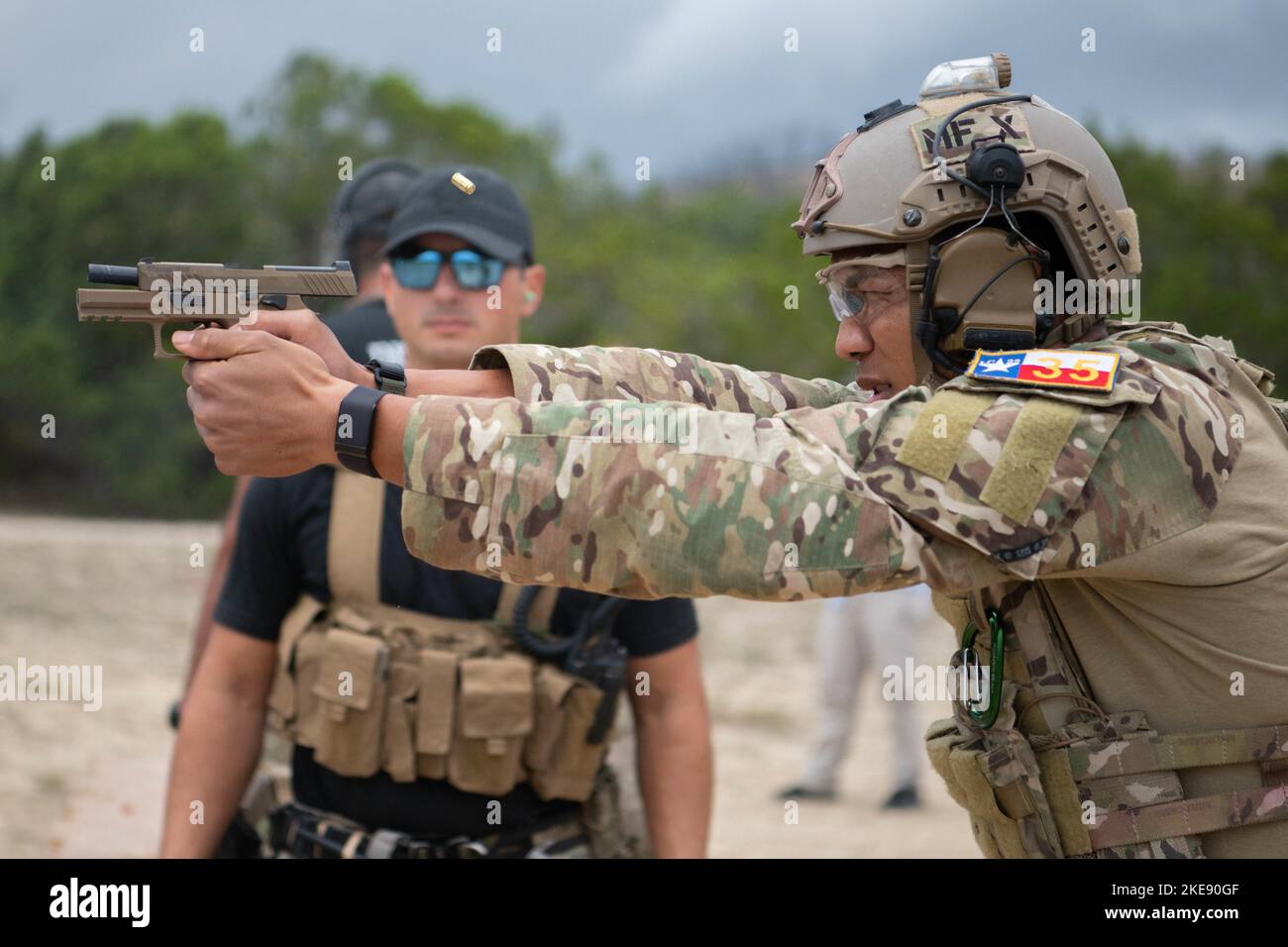 U.S. Air Force Tactical Air Control Party specialist fires his weapon ...