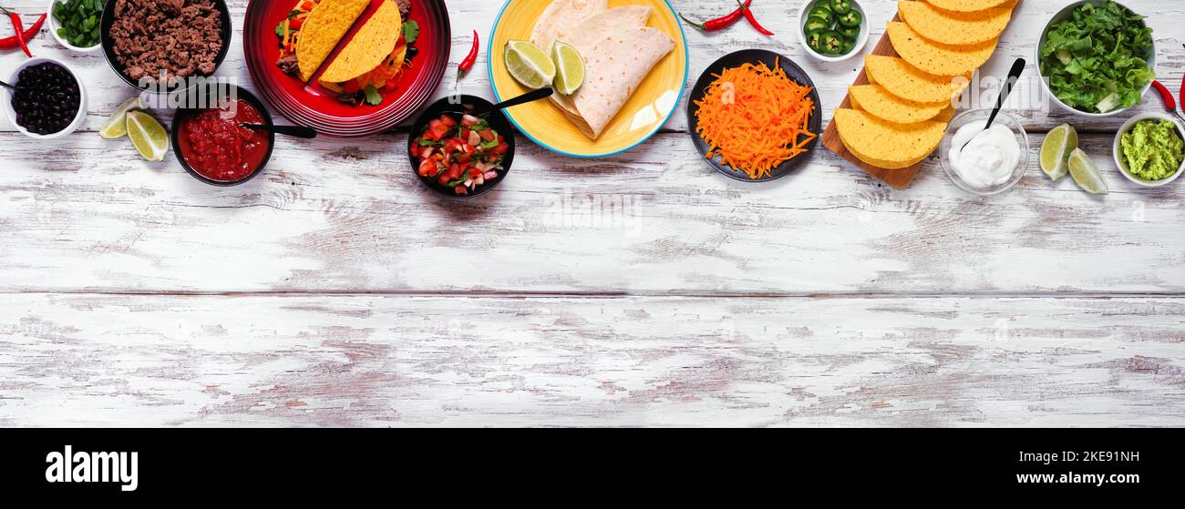 Taco bar top border with an assortment of ingredients. Overhead view on ...