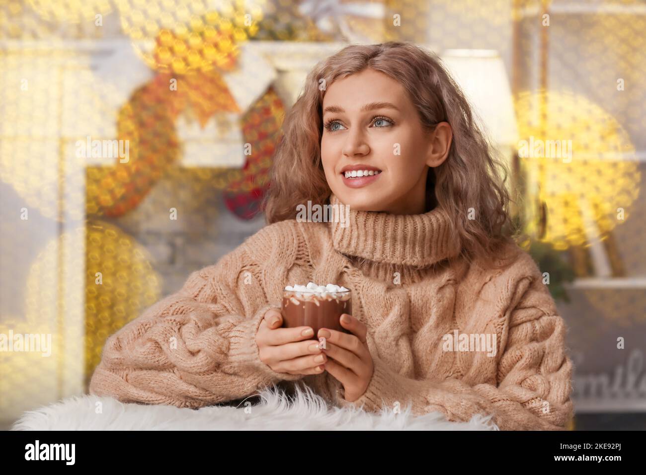 Beautiful young woman drinking hot cocoa at home on Christmas eve Stock ...