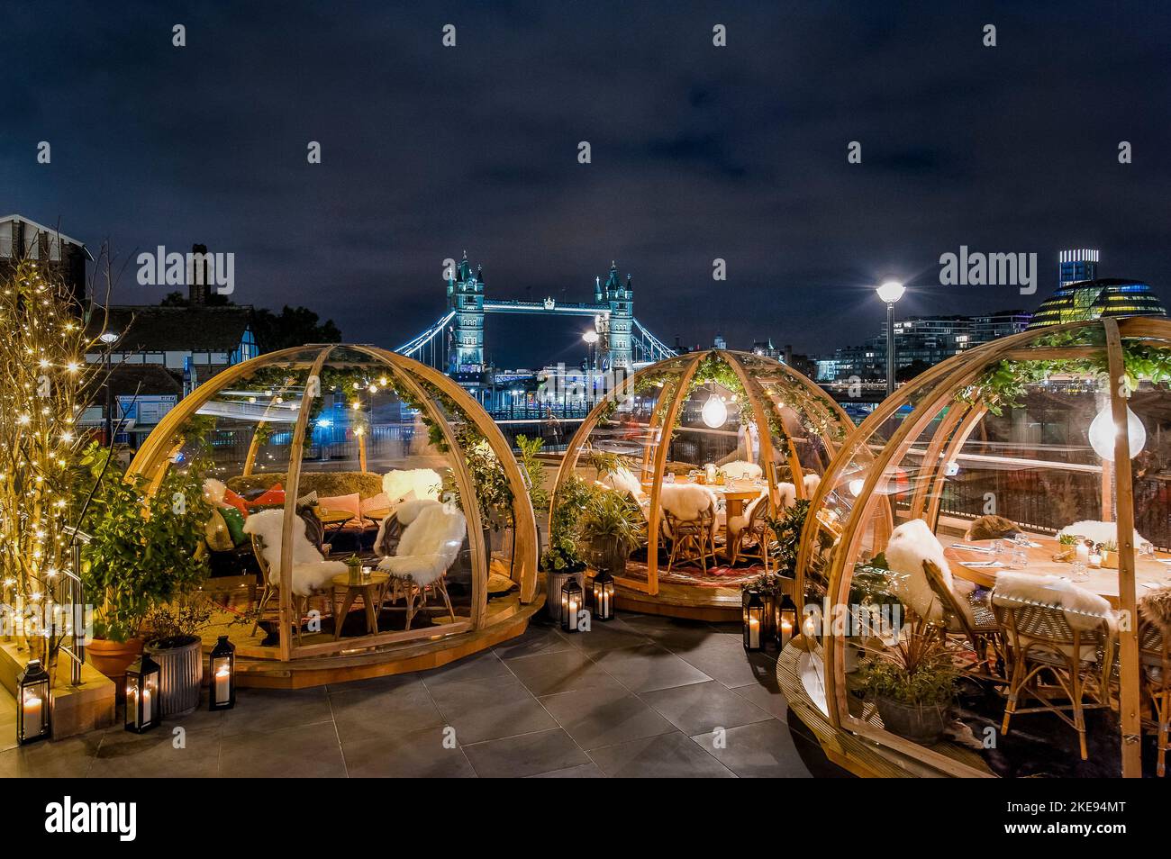 Three igloos close to the River Thames the tower bridge in the ...