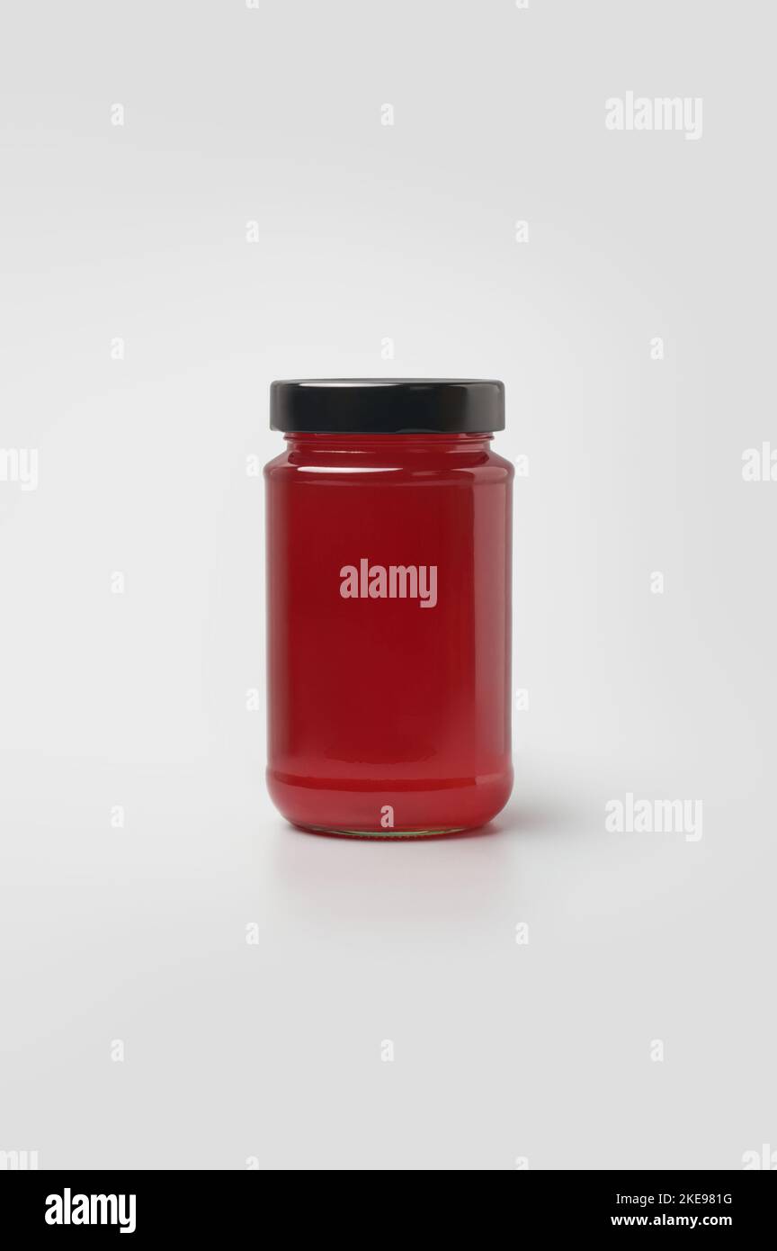 glass jar with bright red jam, bottle with black lid, isolated on ...