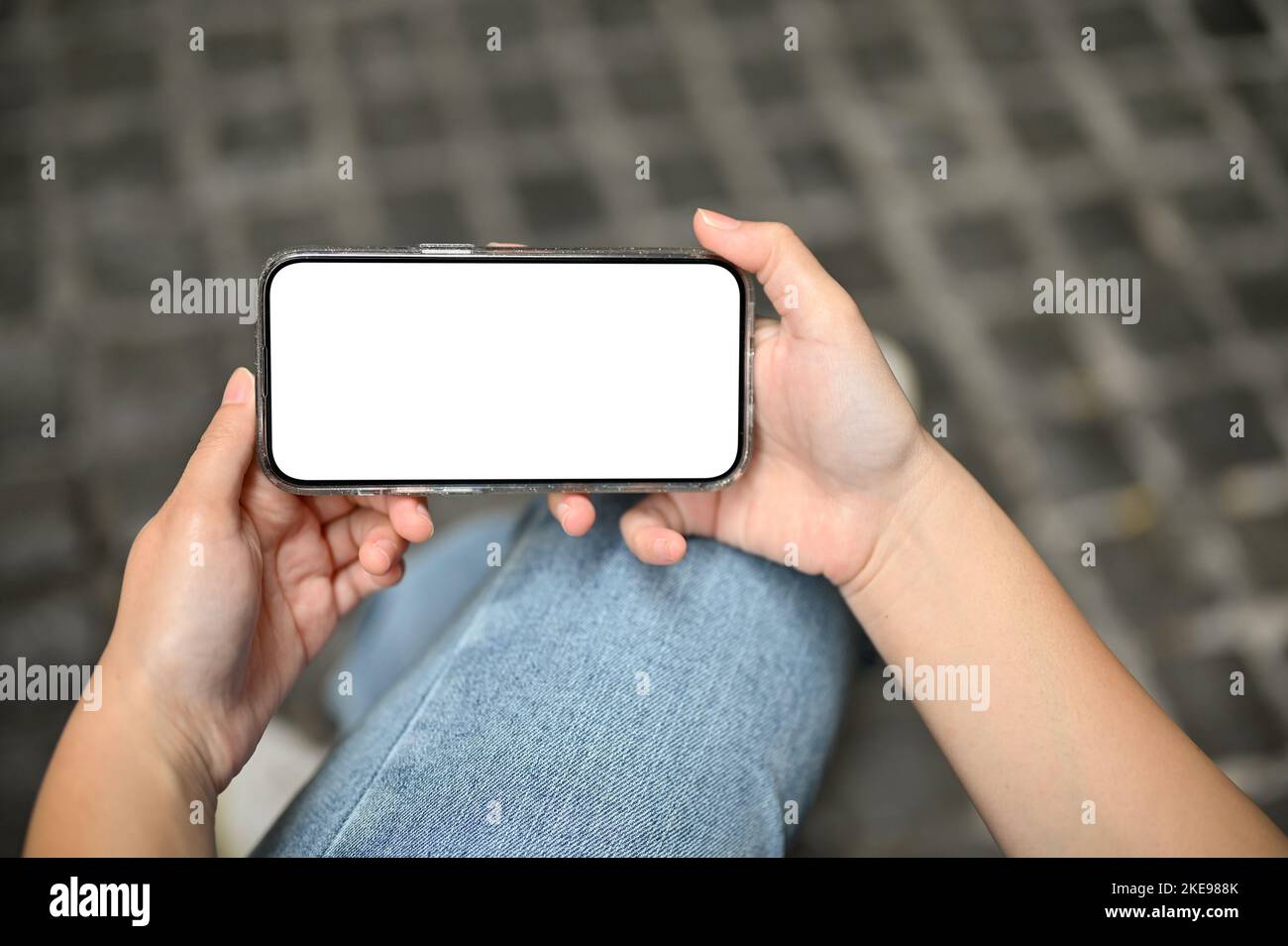 A female using her smartphone while relaxes sitting at the cafe at the ...