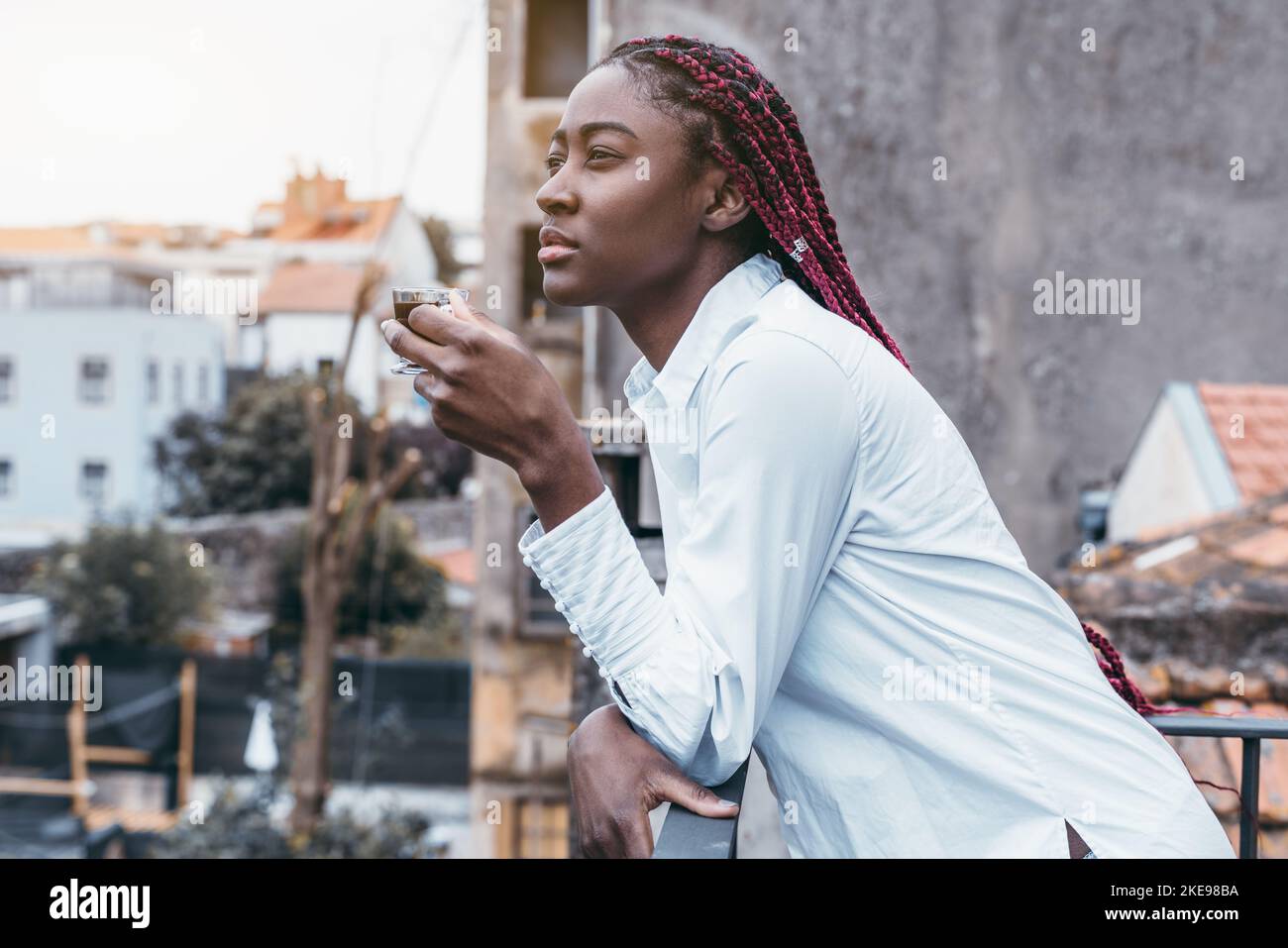 A side profile view of a charming youthful African female with long red ...